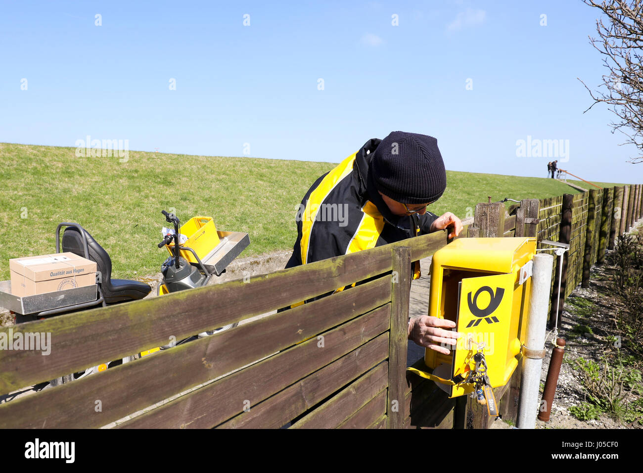 Mailman Michael Stobbe delivers the mail with his electric vehicle on ...