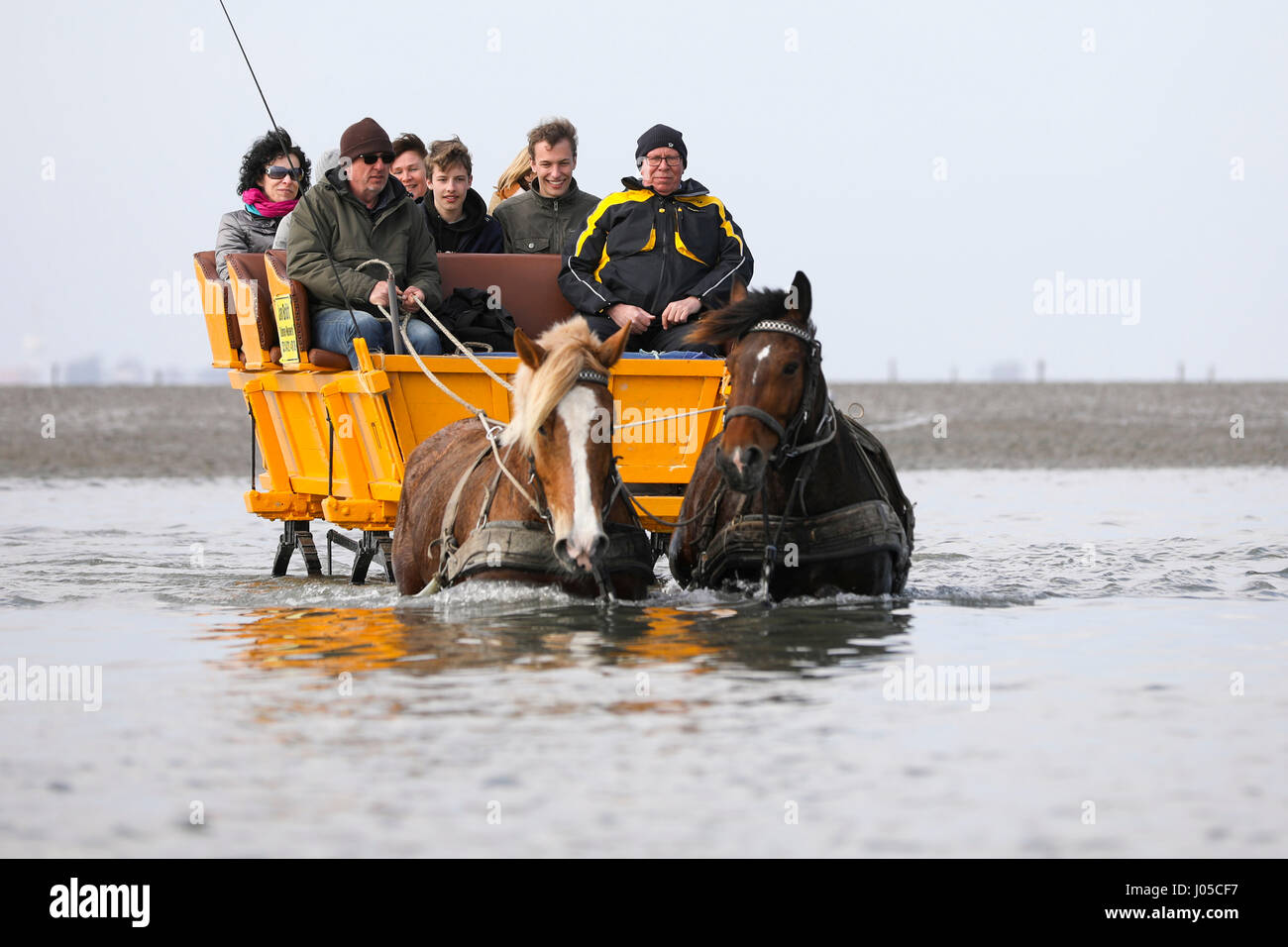 Mailman Michael Stobbe (r), coachman Jan Bruett and holiday guests ride ...