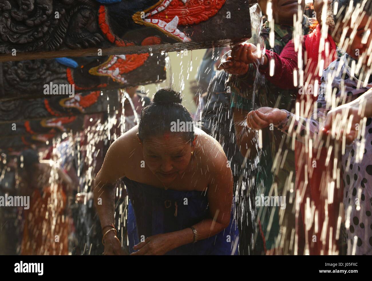 Lalitpur, Nepal. 11th Apr, 2017. A Nepalese devotee takes holy bath at ...