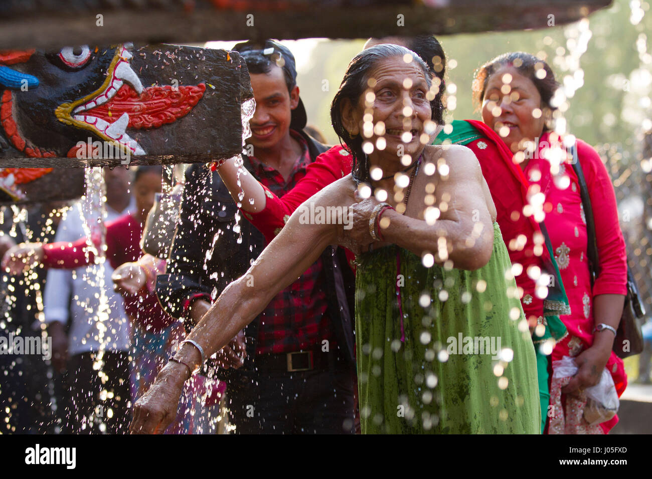 Lalitpur, Nepal. 11th Apr, 2017. Nepalese devotees take holy bath at ...