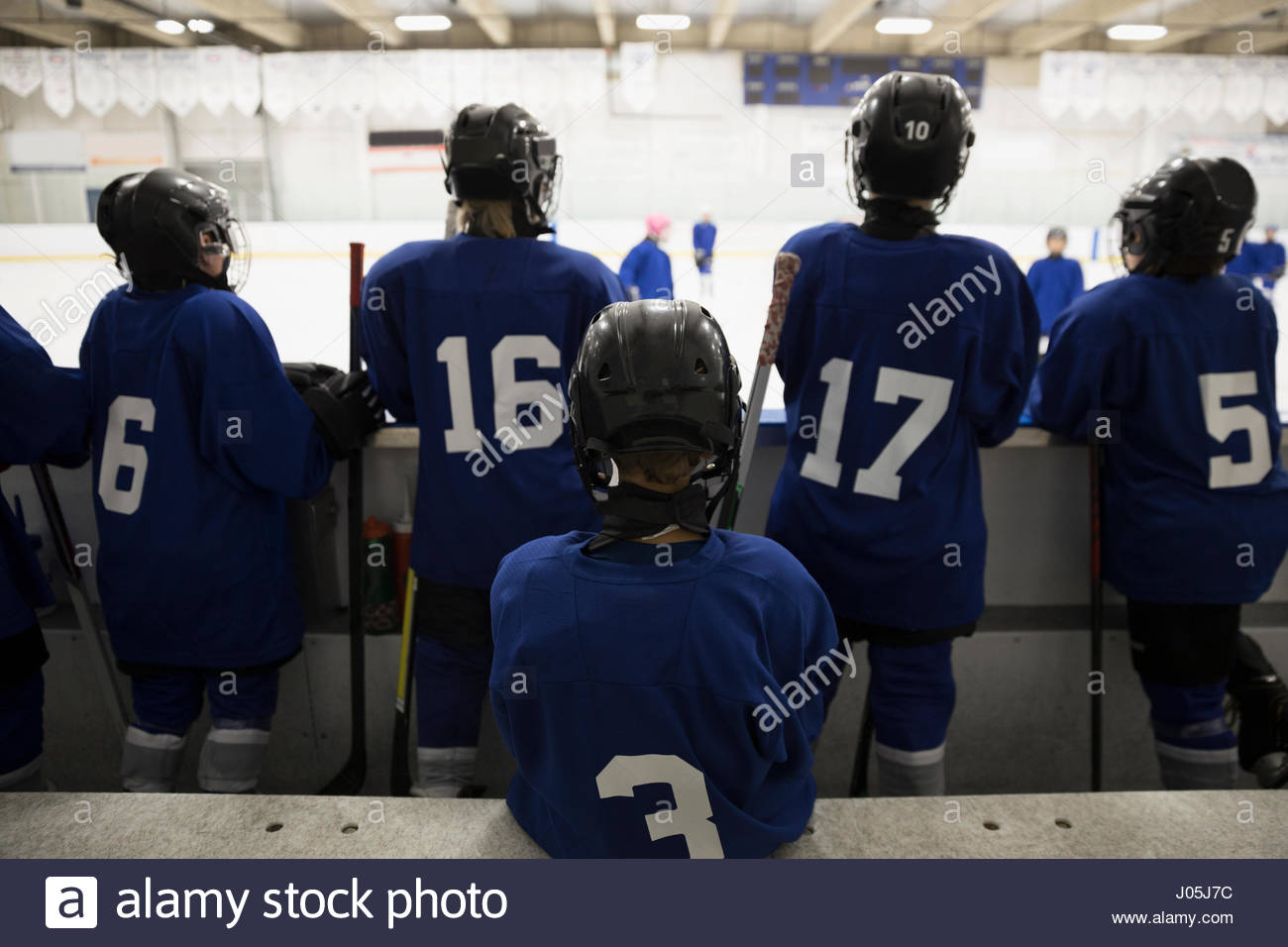 Boy ice hockey players standing and watching game from bench Stock ...