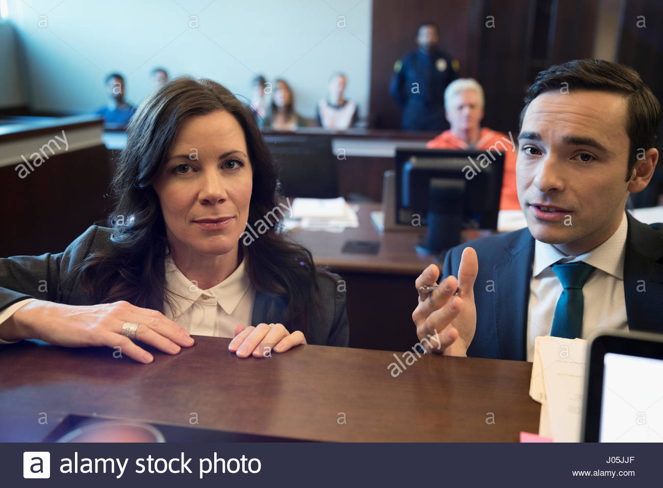 Personal perspective attorneys talking to judge at bench in legal trial ...