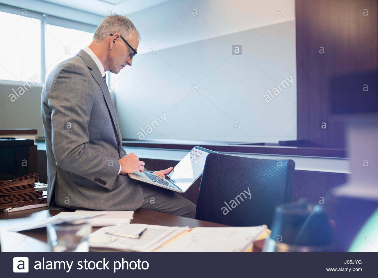 Male prosecutor attorney using laptop in courtroom Stock Photo - Alamy