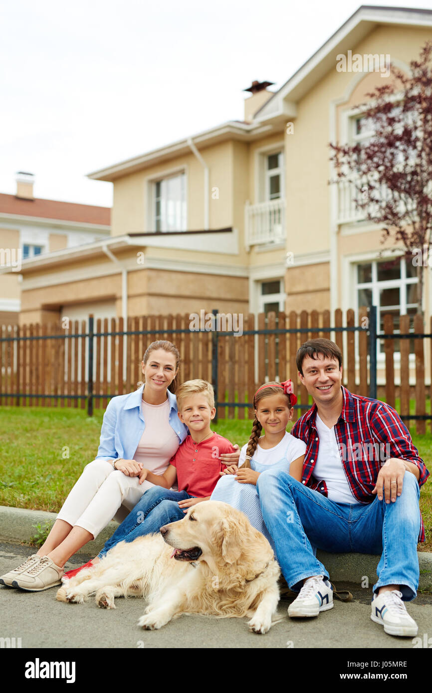Family with pet chilling out on green grass Stock Photo - Alamy