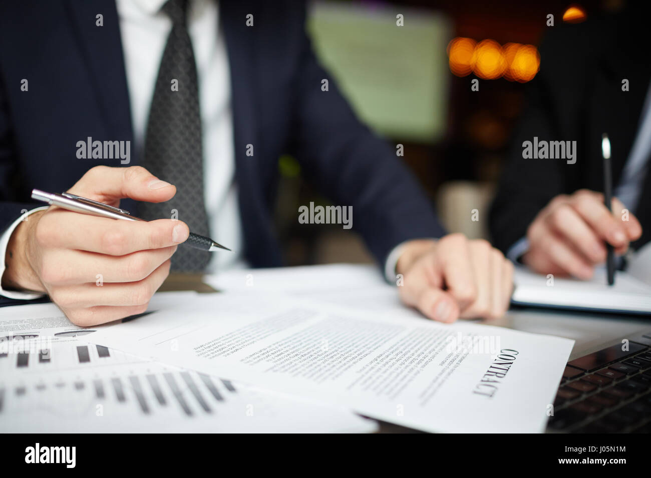 Closeup portrait of two unrecognizable business people wearing black ...