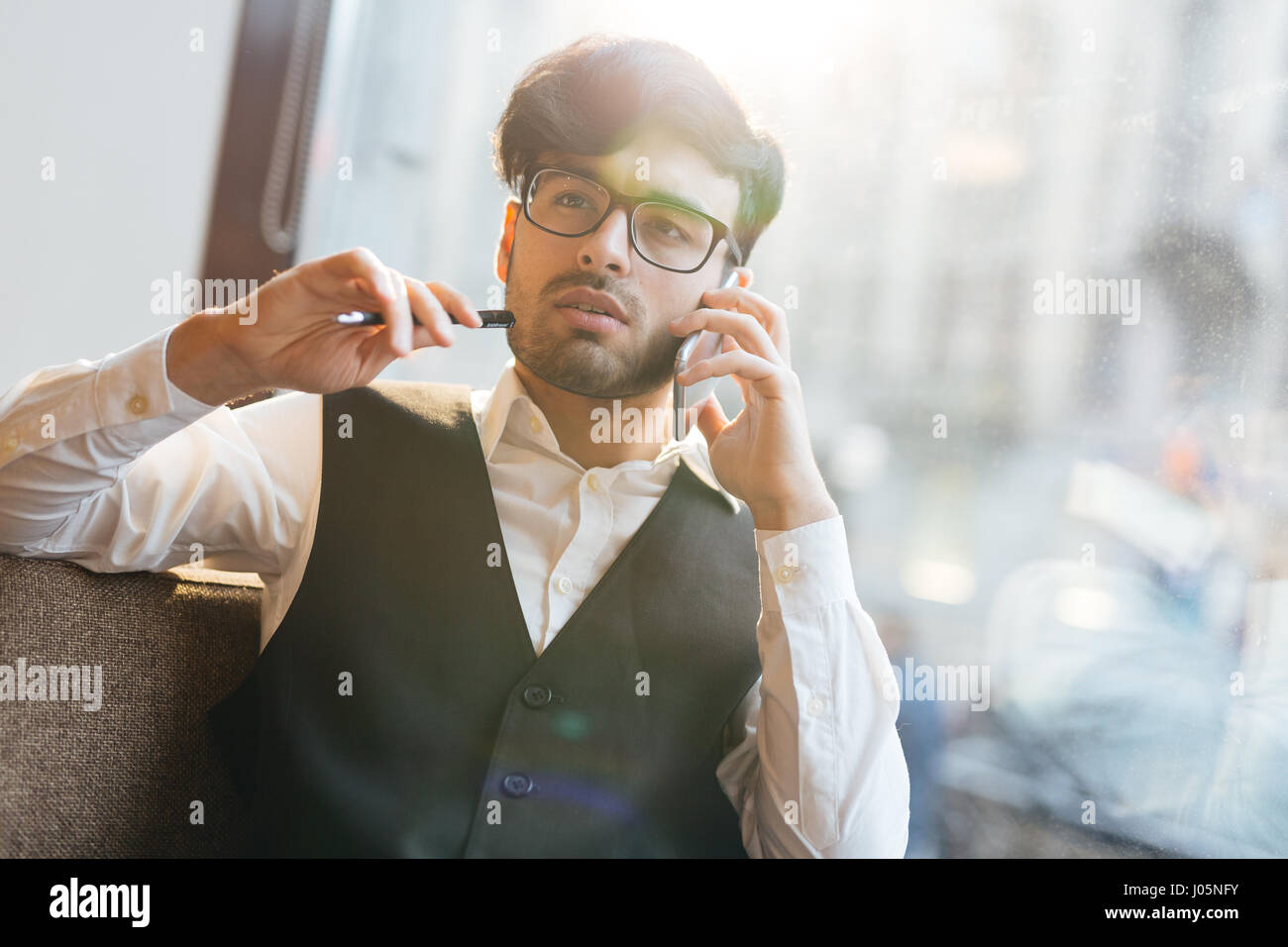 Busy employee speaking on smartphone with co-worker Stock Photo - Alamy