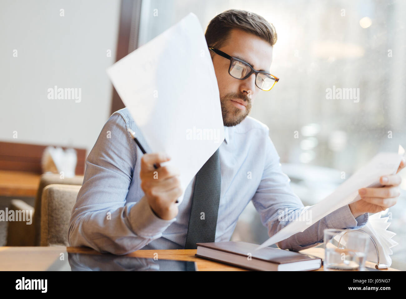 Trader looking through financial papers Stock Photo - Alamy