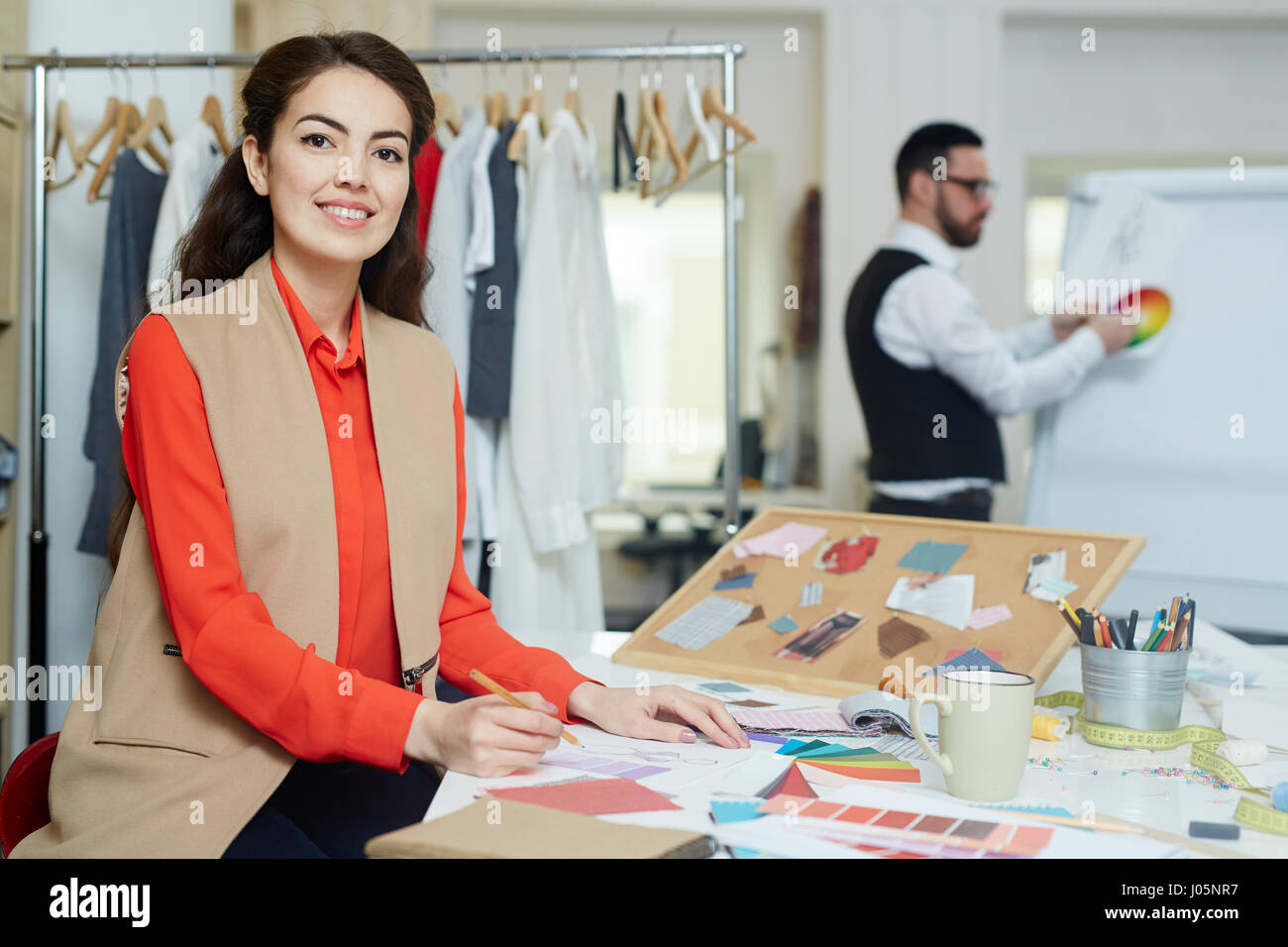 Elegant designer making sketches in notepad Stock Photo - Alamy
