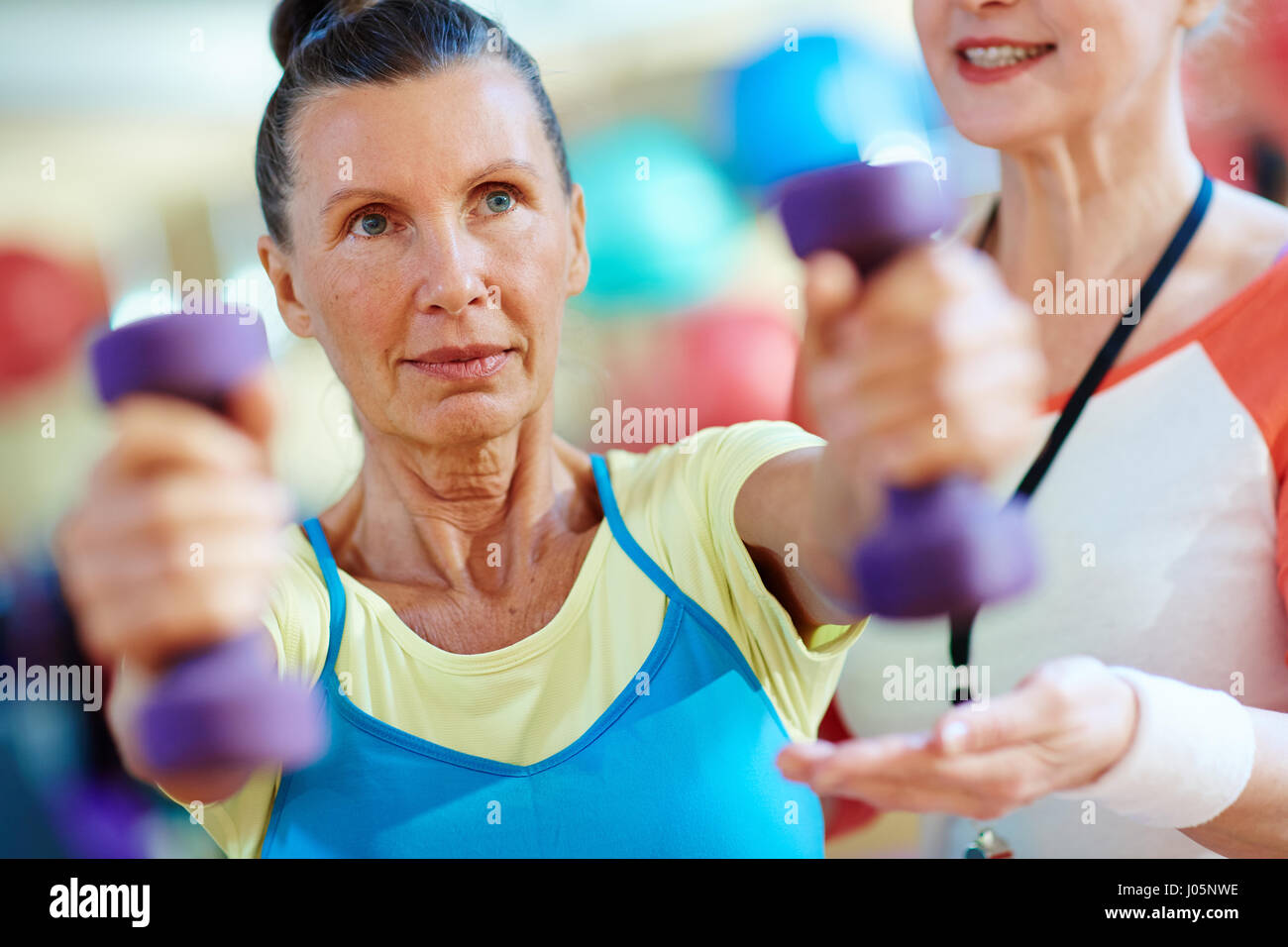 Warm-up of active senior woman in gym Stock Photo - Alamy