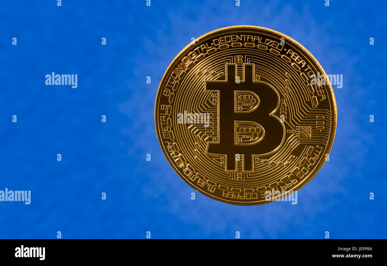 Single bitcoin with blue cloud background Stock Photo - Alamy