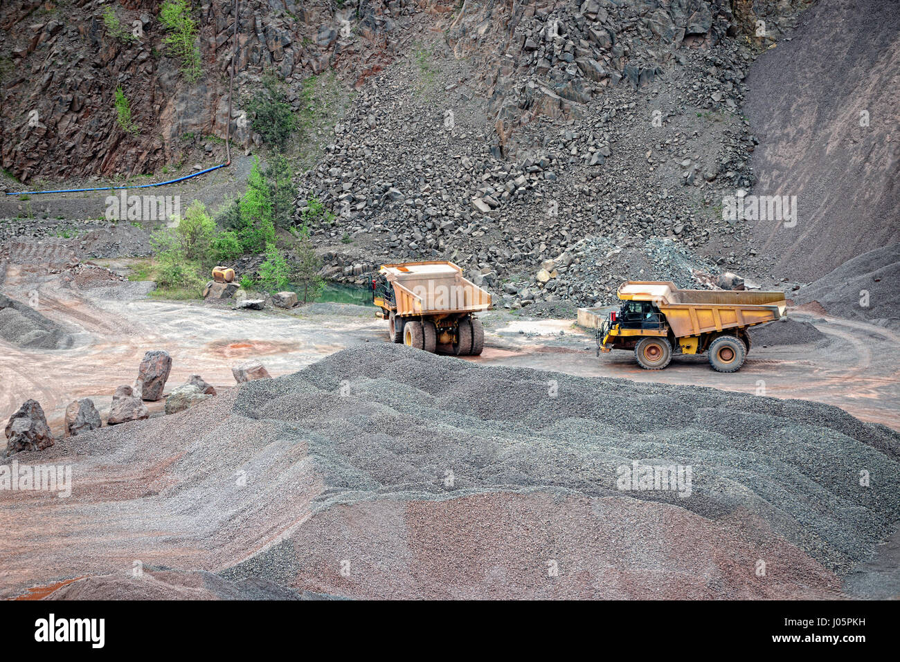 two dumper trucks in a quarry. mining industry Stock Photo - Alamy