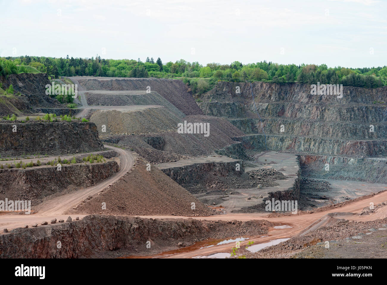 aerial view over a quarry hole. mining industry Stock Photo - Alamy