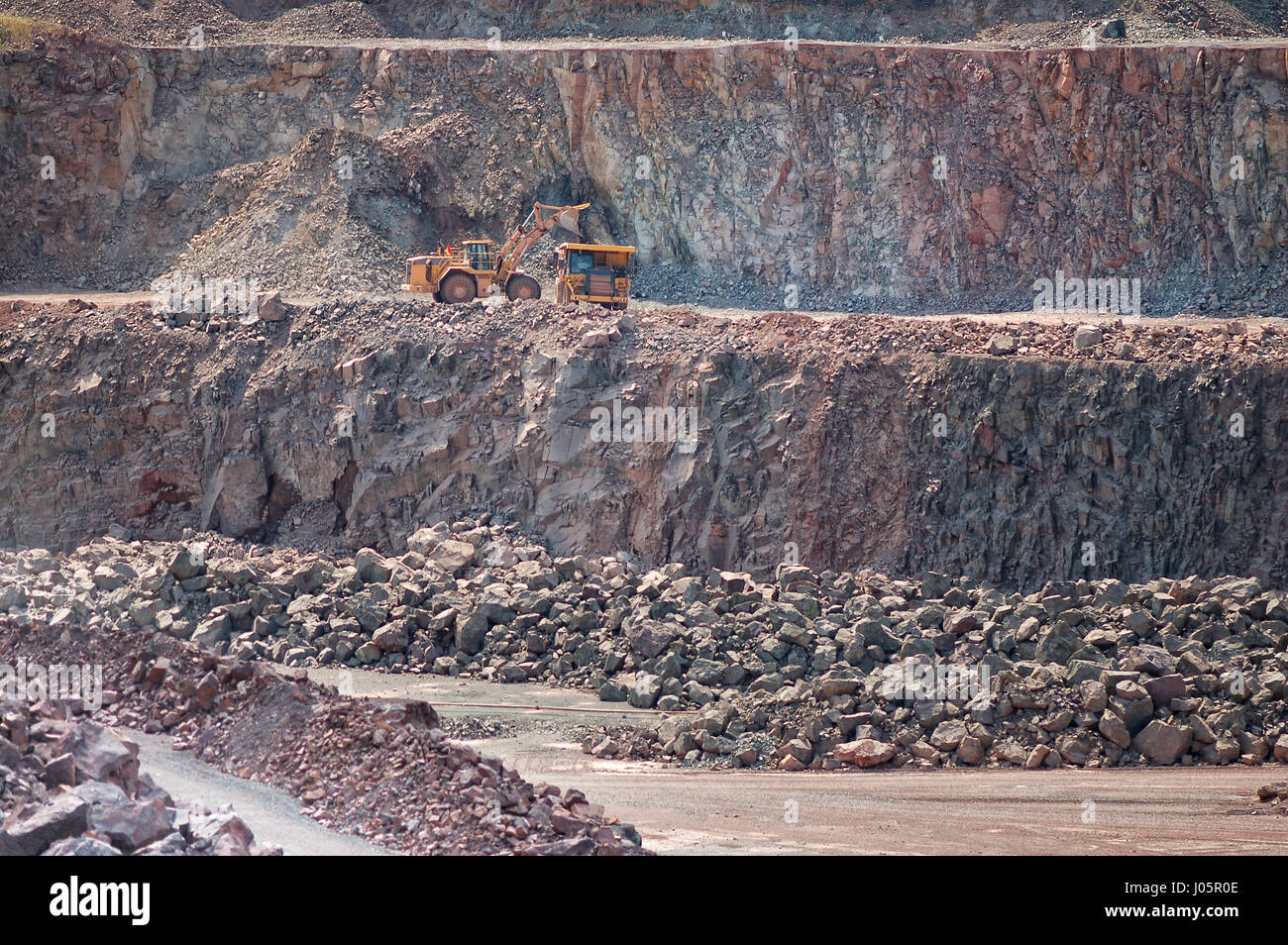 excavator loading dumper truck in a quarry mine Stock Photo - Alamy