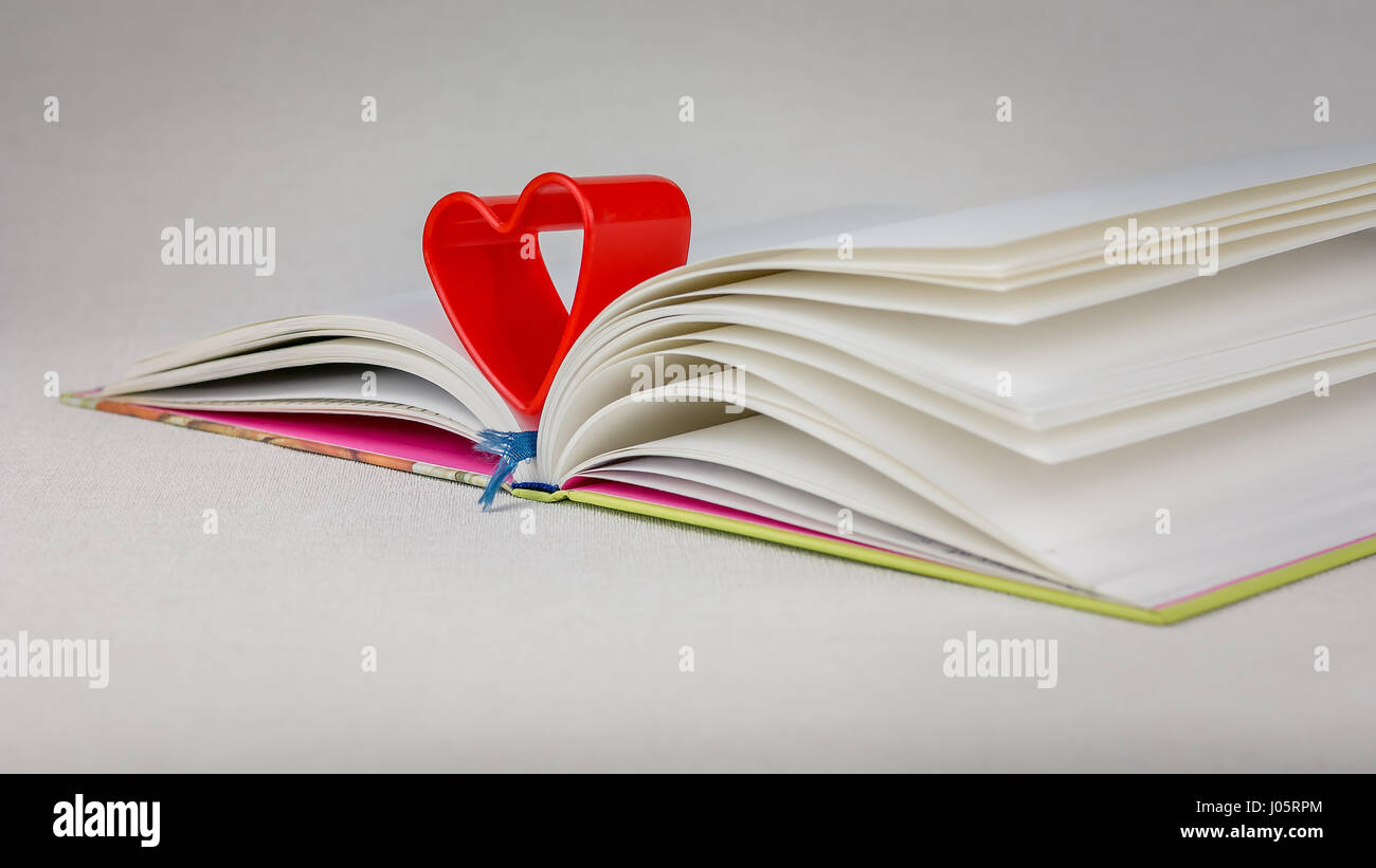 Red heart over diary book on white table Stock Photo - Alamy
