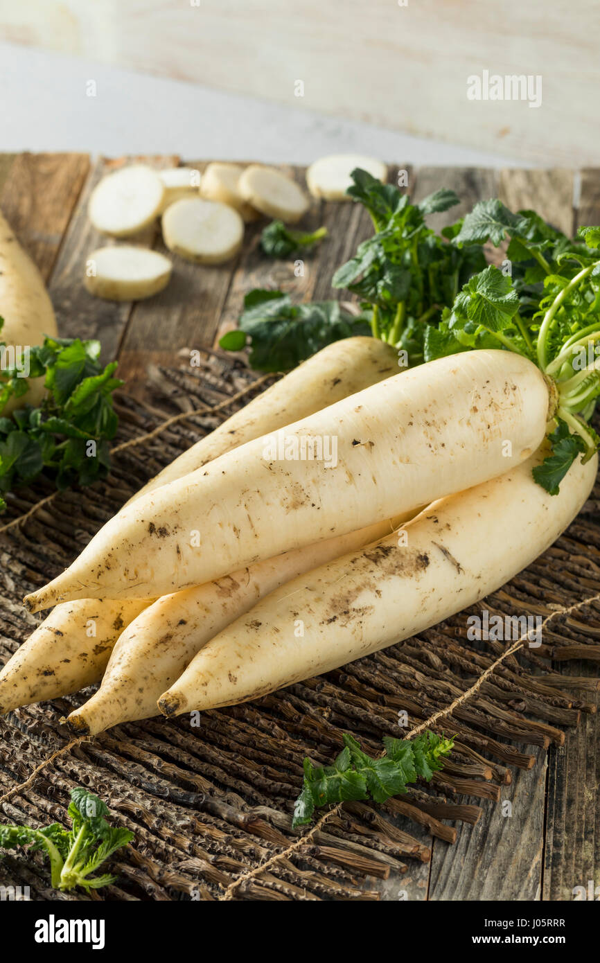 Raw Organic White Daikon with Green Leaves Stock Photo - Alamy