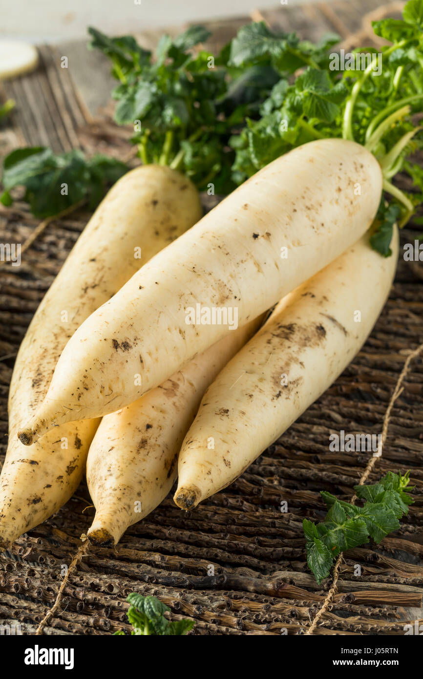 Raw Organic White Daikon with Green Leaves Stock Photo - Alamy