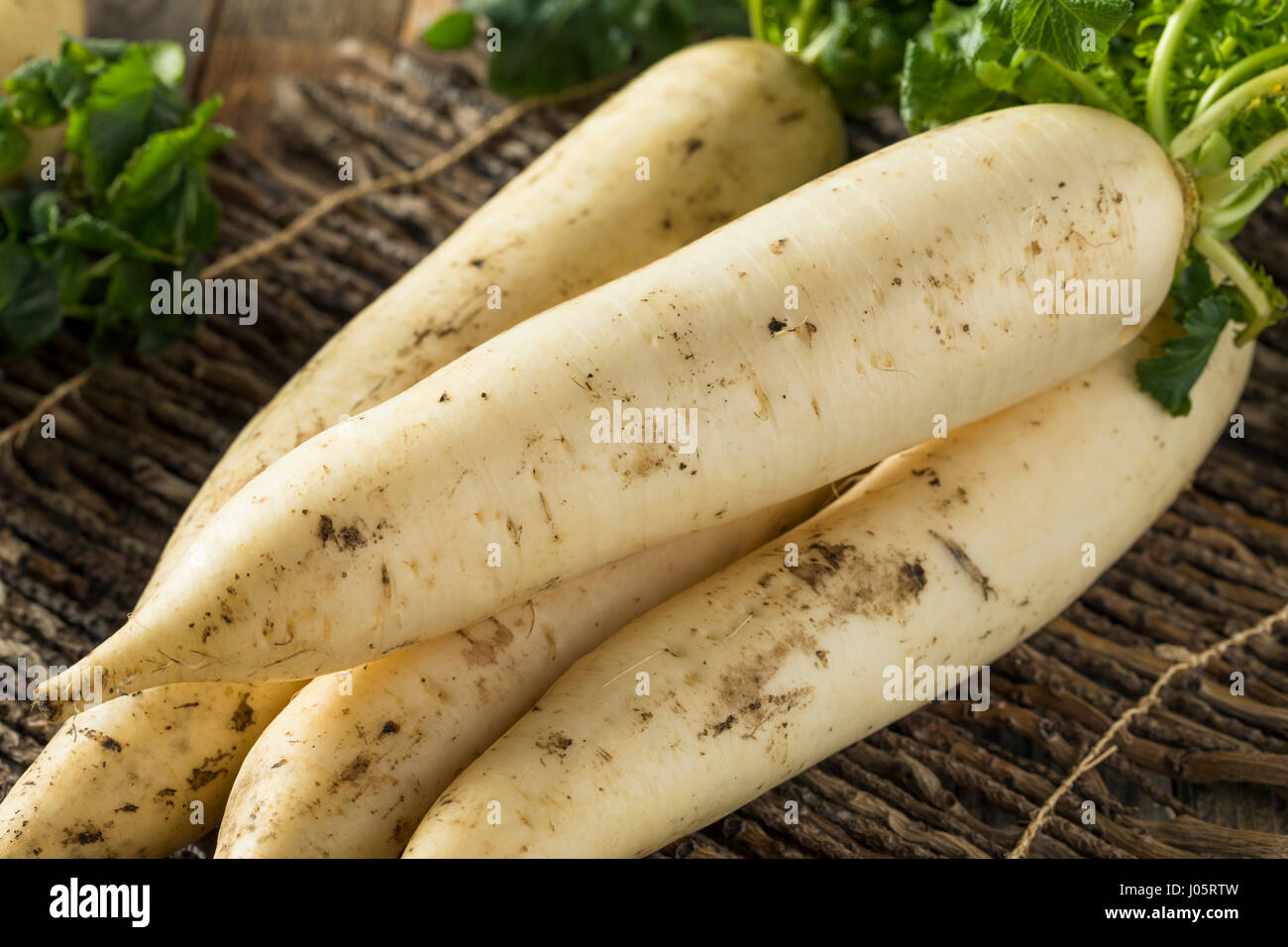 Raw Organic White Daikon with Green Leaves Stock Photo - Alamy
