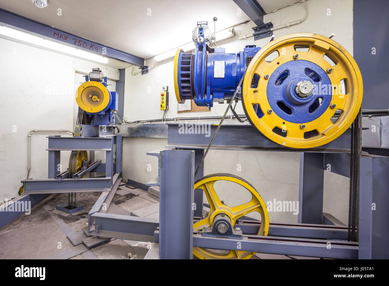 iron cables on a wheel of a motor of the elevator Stock Photo - Alamy