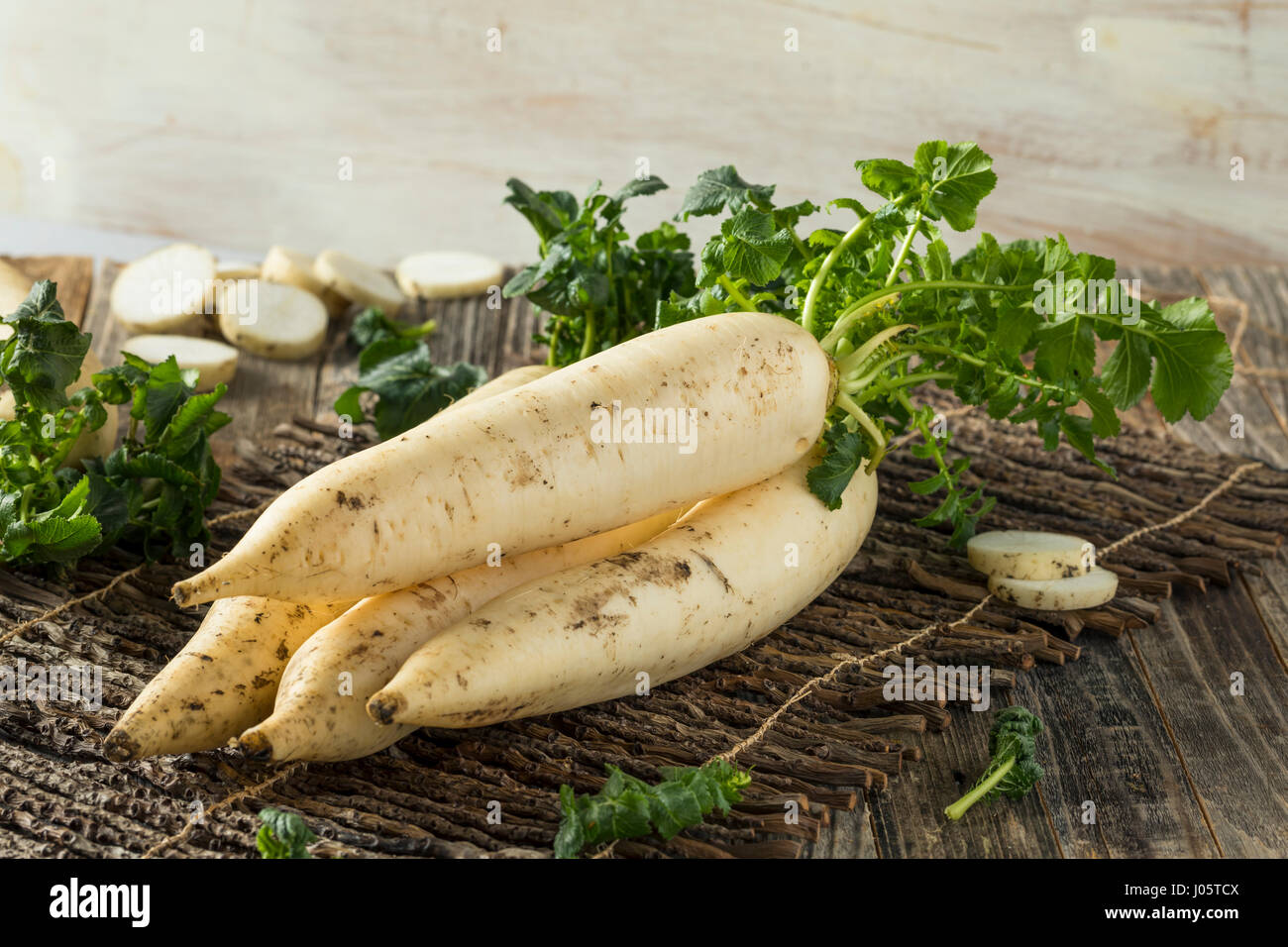 Raw Organic White Daikon with Green Leaves Stock Photo - Alamy