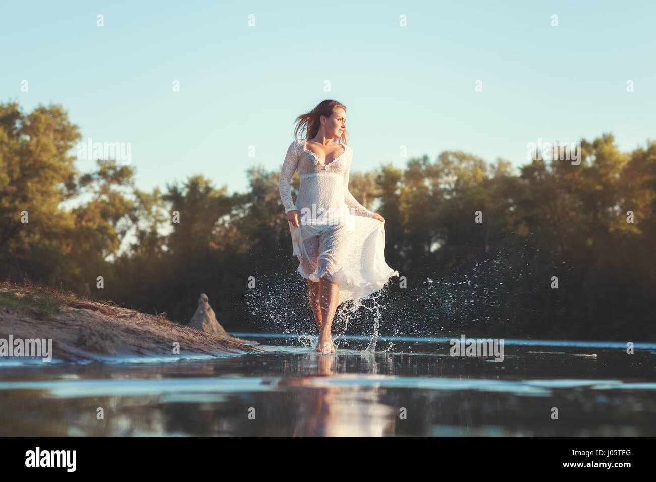 Woman running on water, water splashes feet make it to the lake in the ...