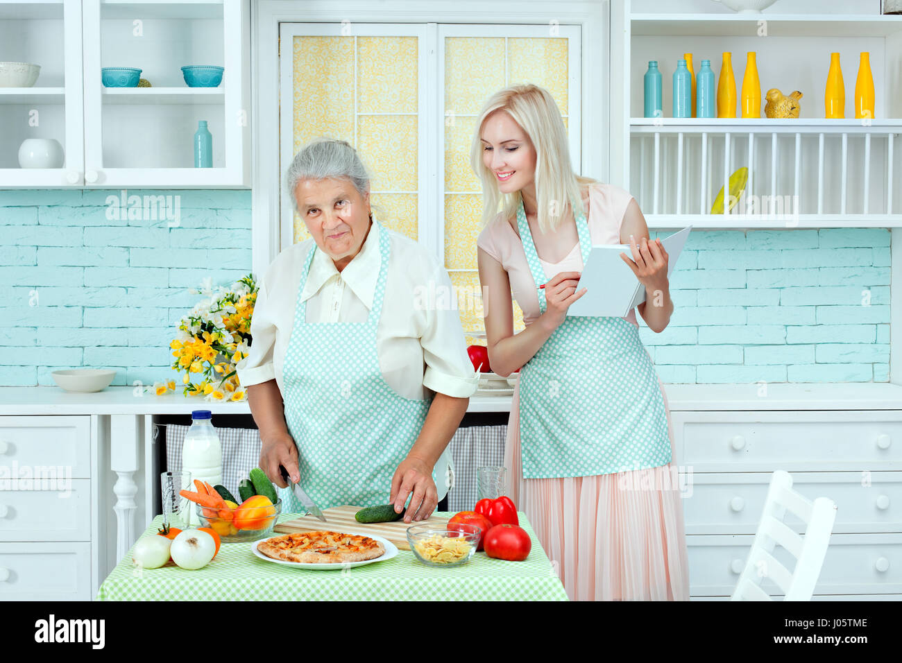 Grandma taught to cook a young girl in the kitchen Stock Photo - Alamy