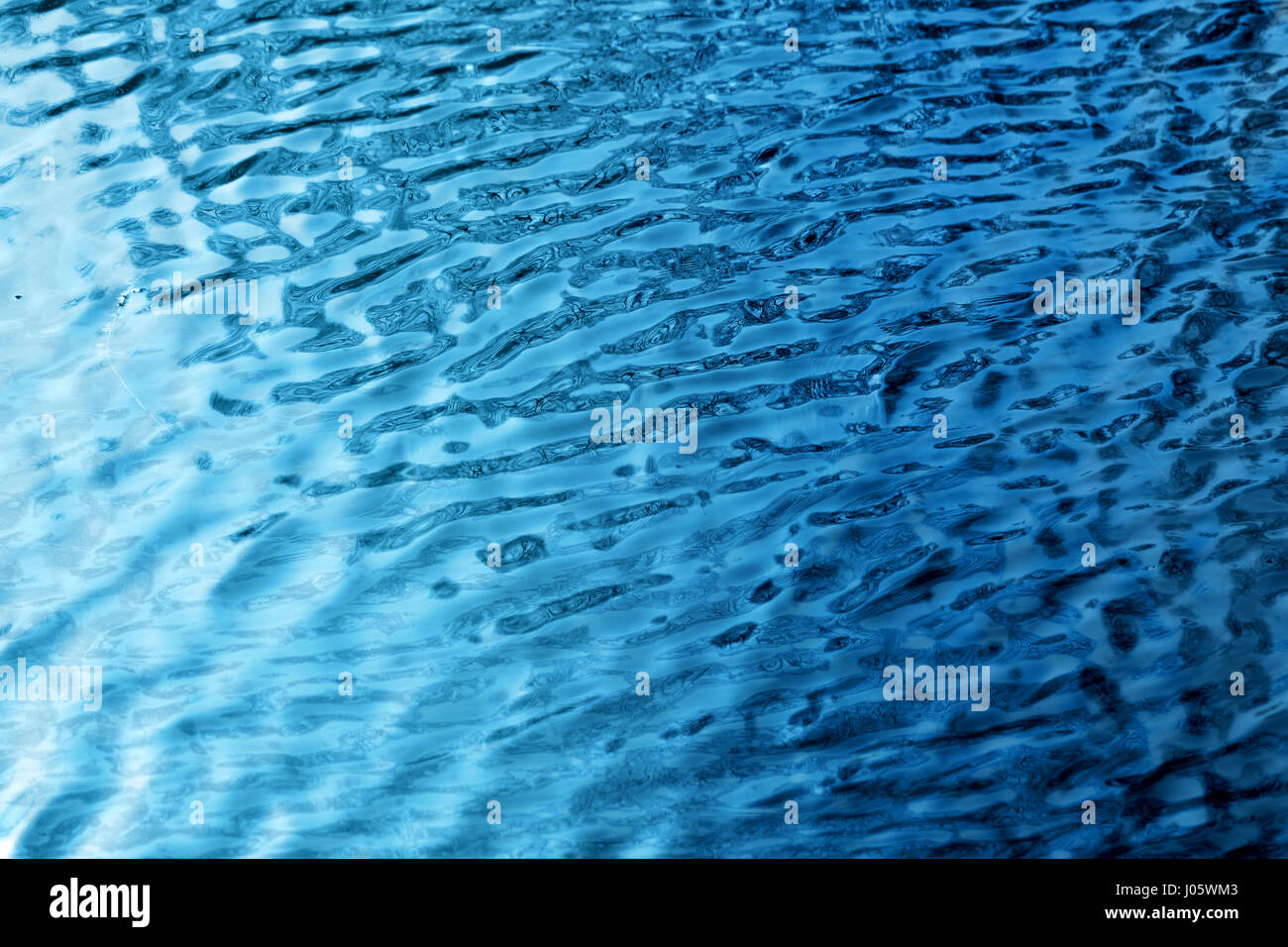 Photo of a blue bright water texture in a river with sun glares Stock ...