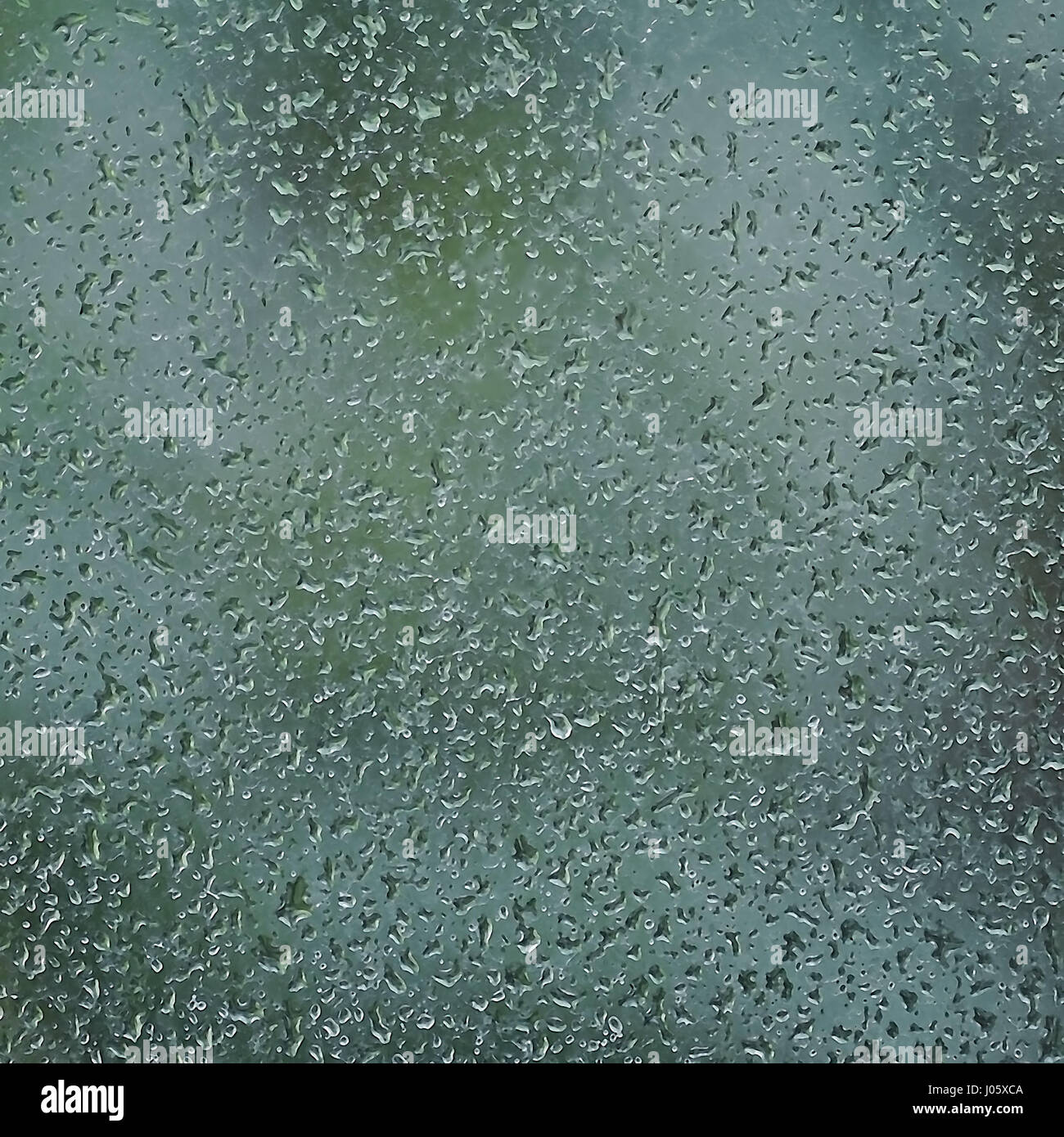 Rainy day, raindrops on wet window glass, vertical bright abstract rain ...