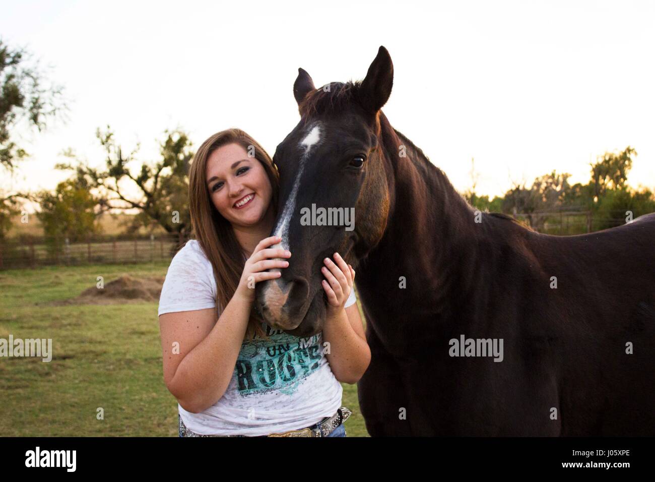 girl snuggling horse Stock Photo - Alamy