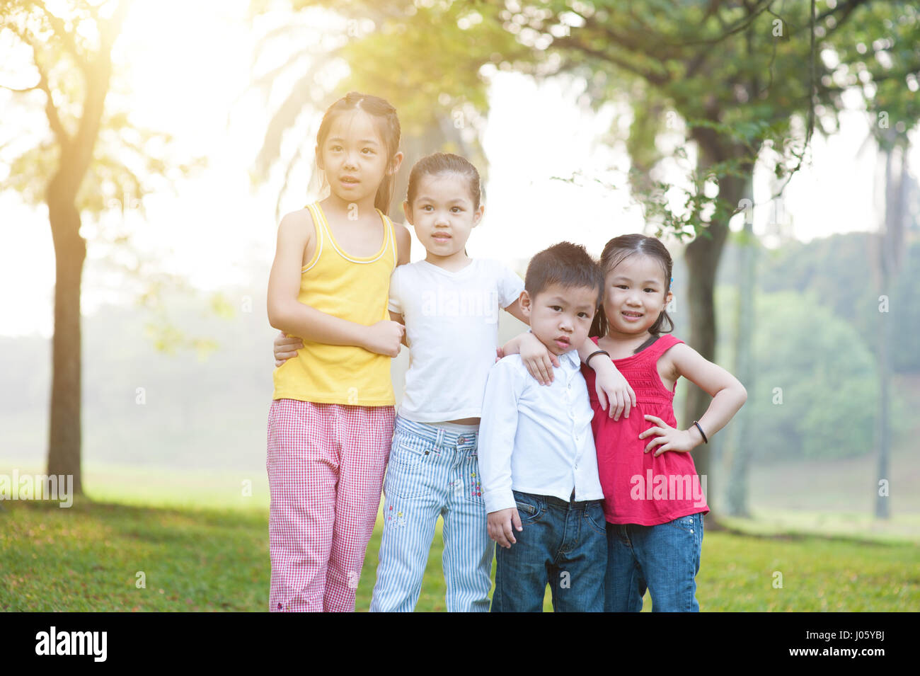 Portrait of four Asian children at park. Little girls and boy having ...