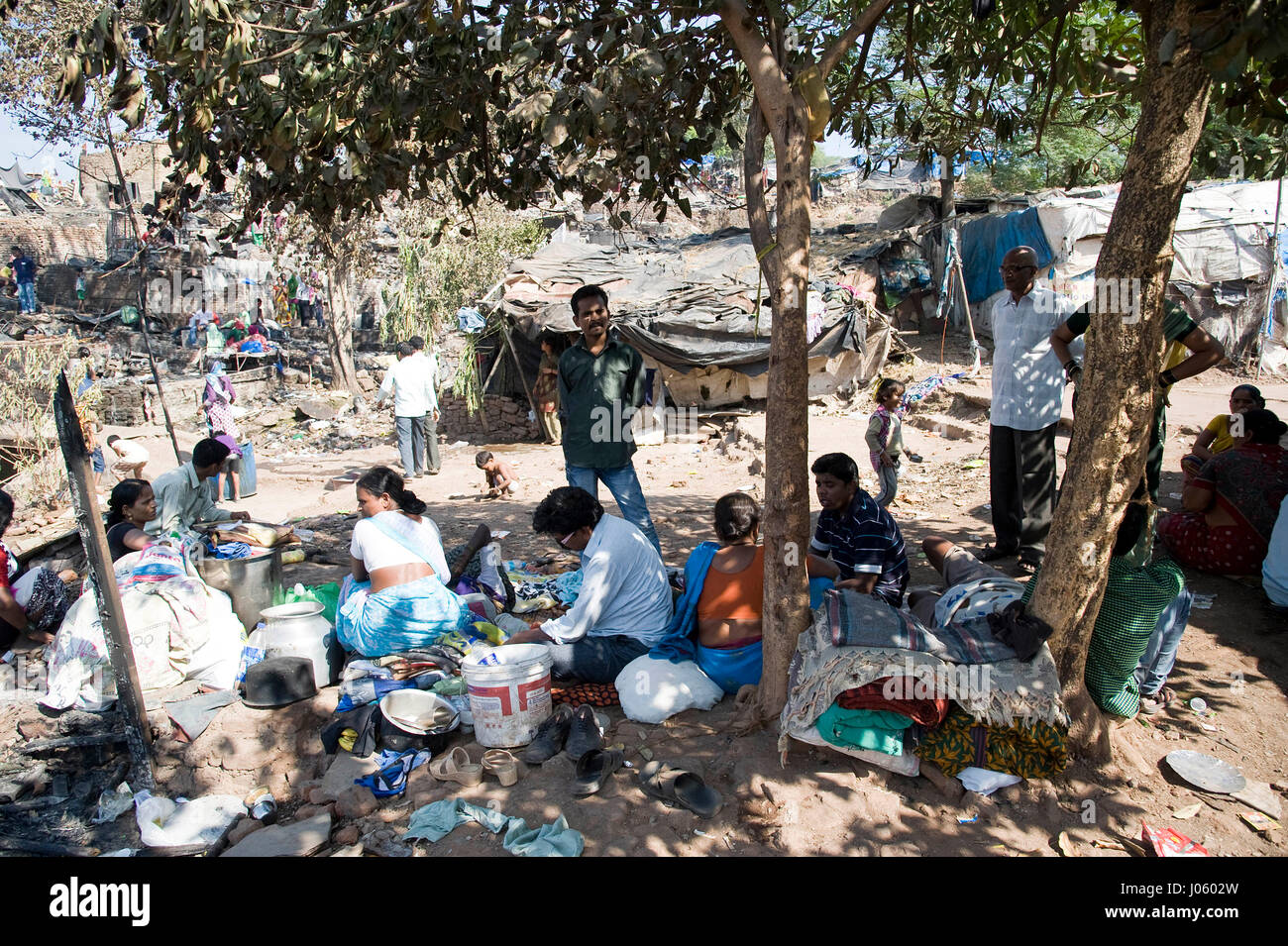 People sitting after slum damaged in fire, damu nagar, kandivali ...