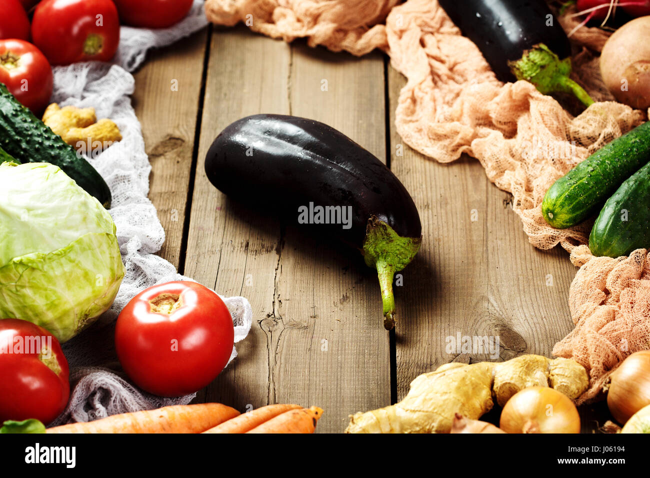 Great eggplant (aubergine) close-up among fresh vegetables. Selective ...