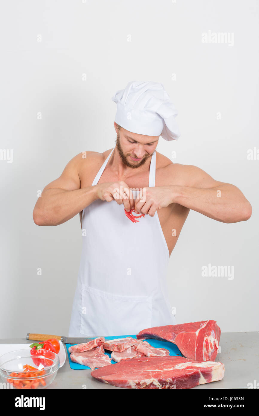 chef bodybuilder preparing large chunks of raw meat. natural proteins ...