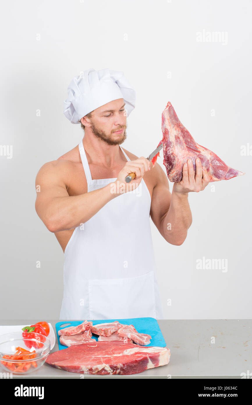 chef bodybuilder preparing large chunks of raw meat. natural proteins ...