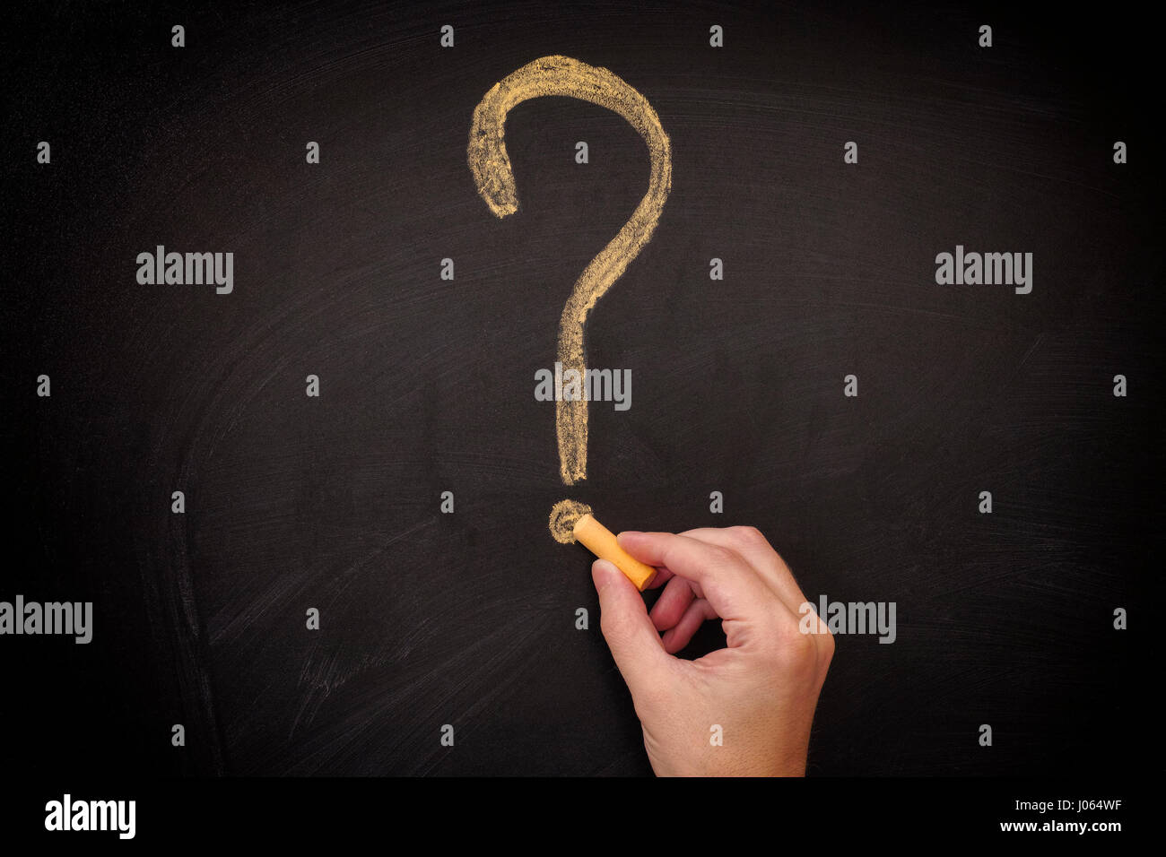 Hand drawing a Question mark on blackboard. Close up Stock Photo - Alamy
