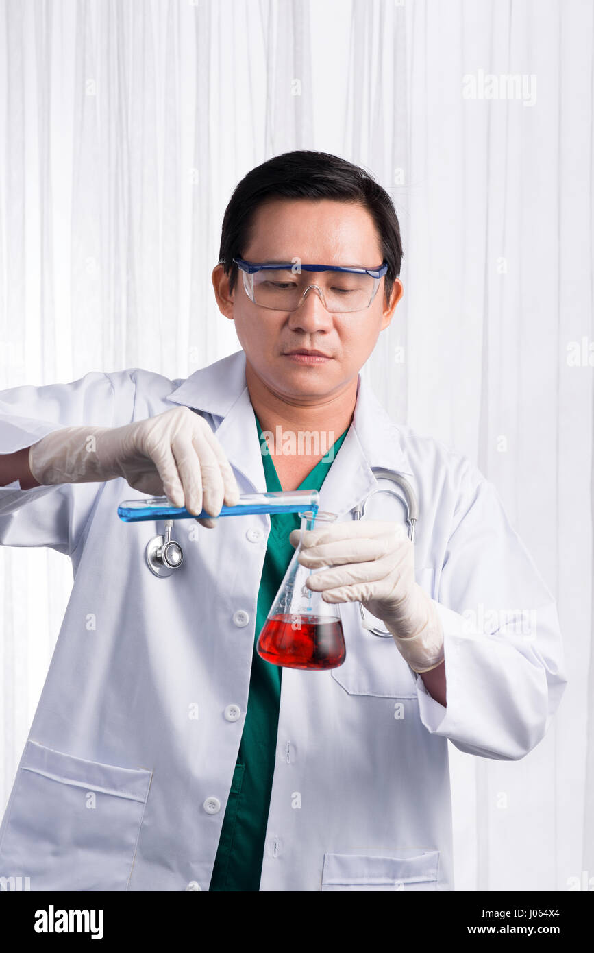 Male scientist holds and examine samples Stock Photo - Alamy