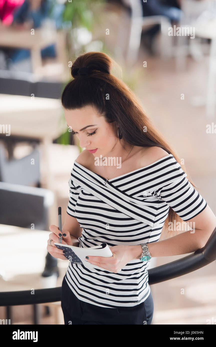 Woman writing notebook check shirt hi-res stock photography and images ...