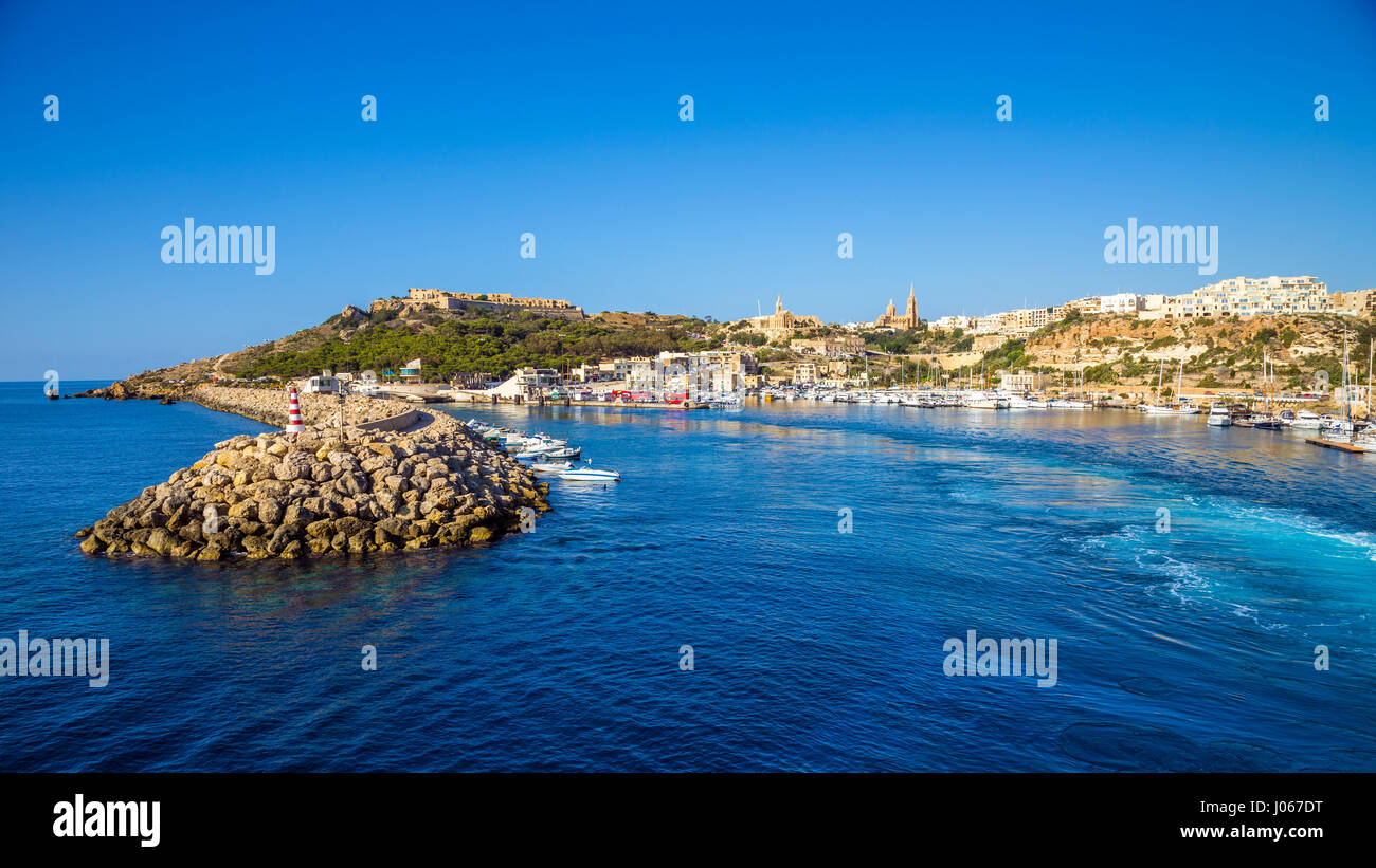 Gozo, Malta - The ancient port of Mgarr with lighthouse on the island ...