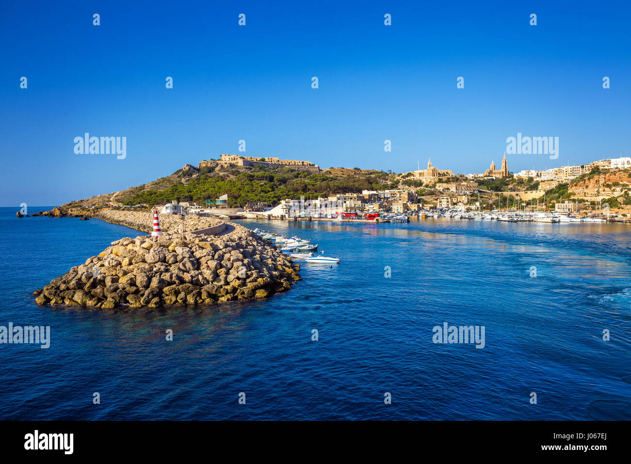 Gozo, Malta - The ancient port of Mgarr with lighthouse on the island ...