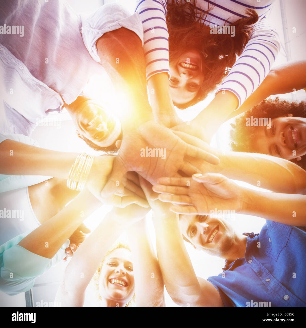 Happy creative team stacking hands hi-res stock photography and images ...