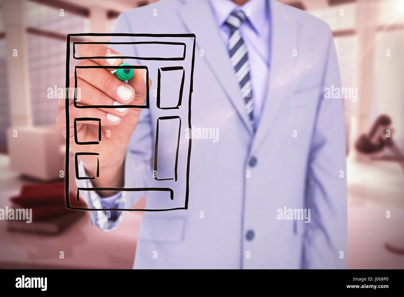 Midsection of businessman writing with marker against computer ...