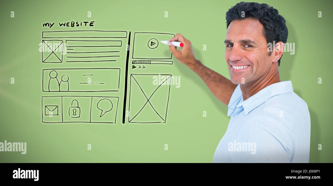 Handsome man writing something with red markers against green ...