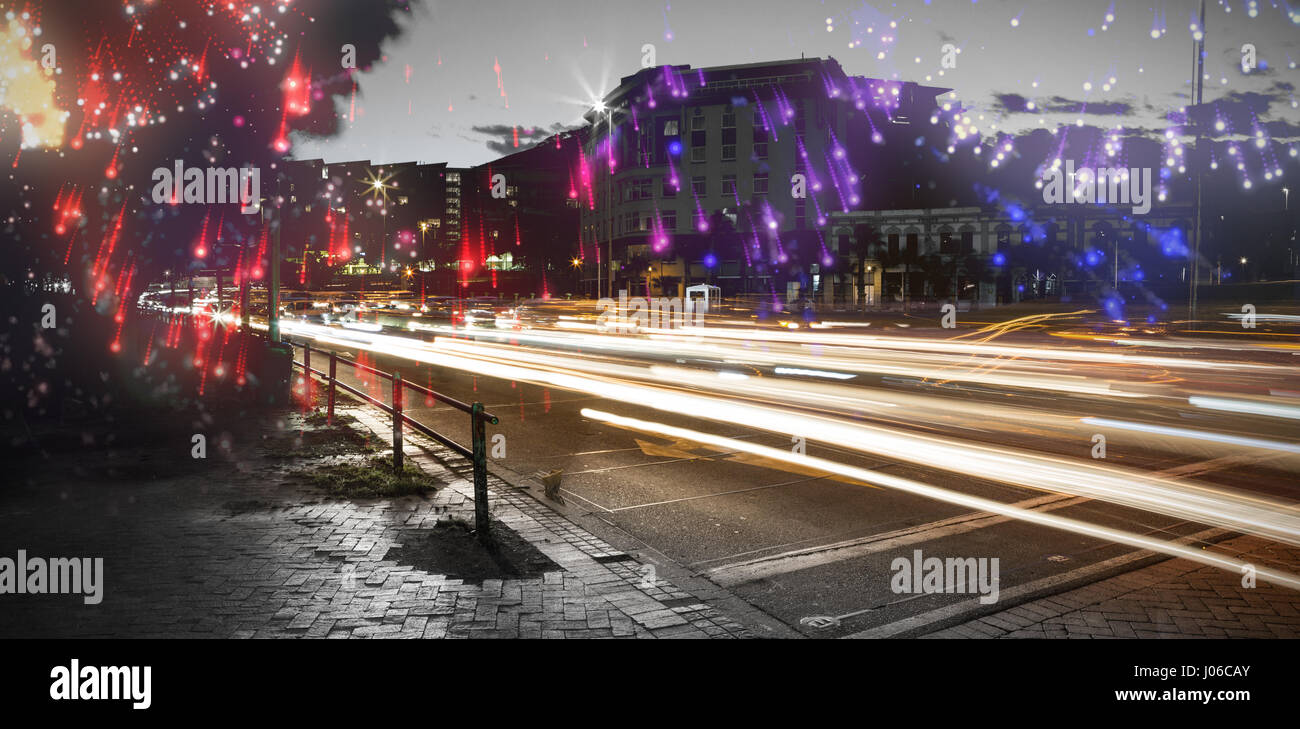 Colourful fireworks exploding on black background against light trails ...