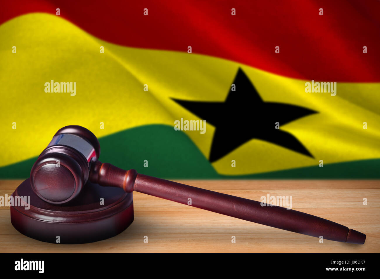 Hammer and gavel against 3d digitally generated ghana national flag ...