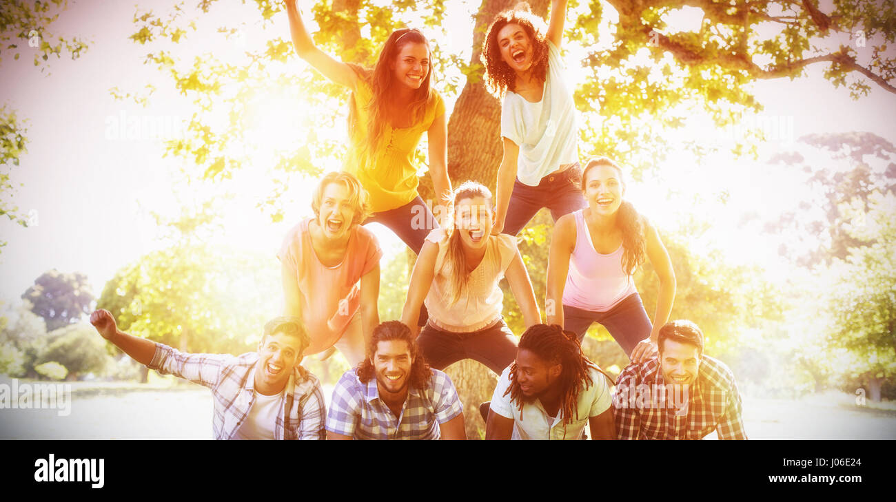 Happy friends in the park making human pyramid on a sunny day Stock ...