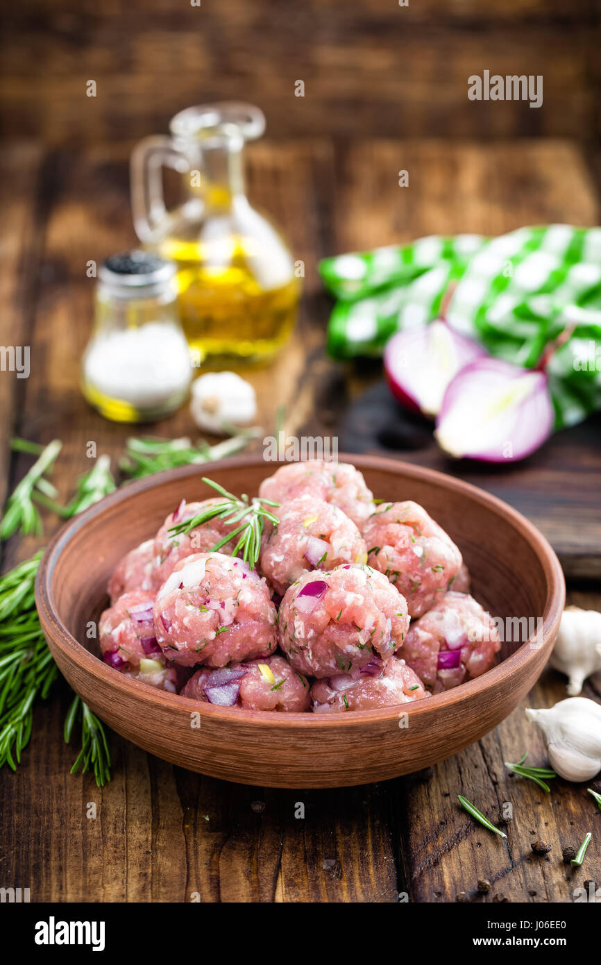 Raw meatballs close-up on wooden background Stock Photo - Alamy