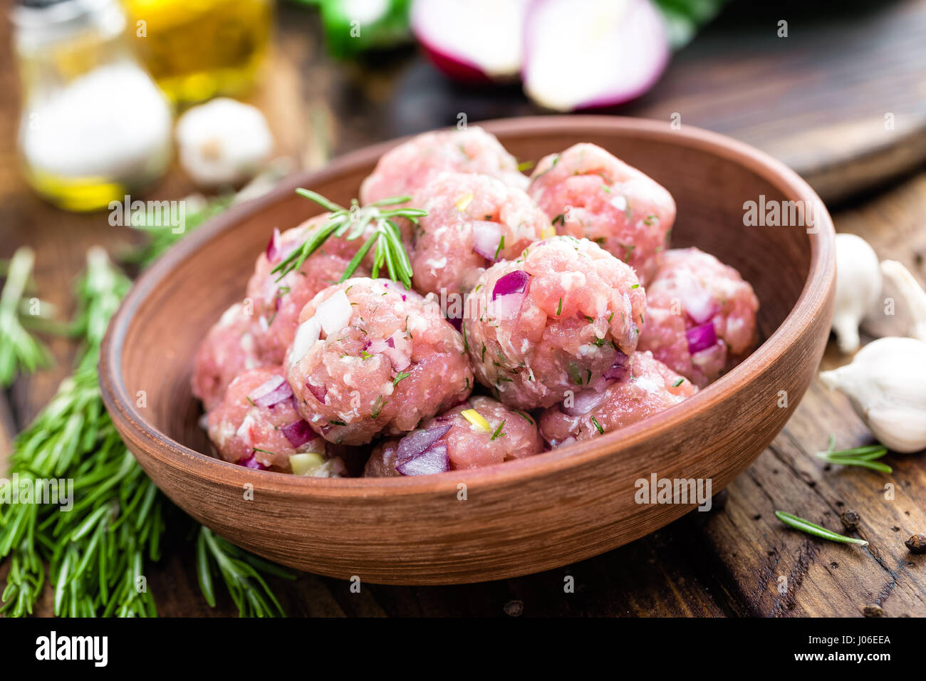Raw meatballs close-up on wooden background Stock Photo - Alamy