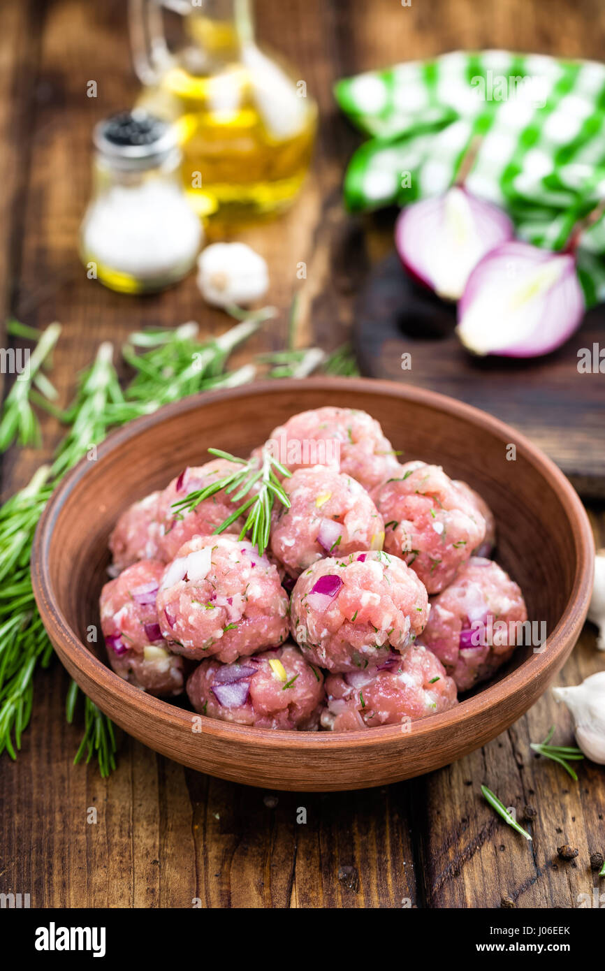 Raw meatballs close-up on wooden background Stock Photo - Alamy