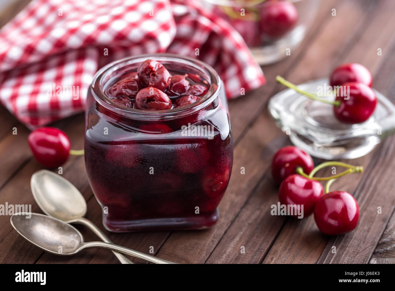 Berries cherry with syrup in a glass jar. Canned fruit Stock Photo - Alamy