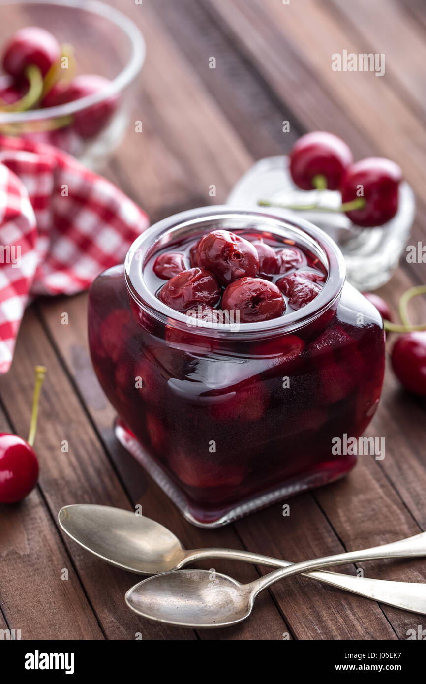 Berries cherry with syrup in a glass jar. Canned fruit Stock Photo - Alamy