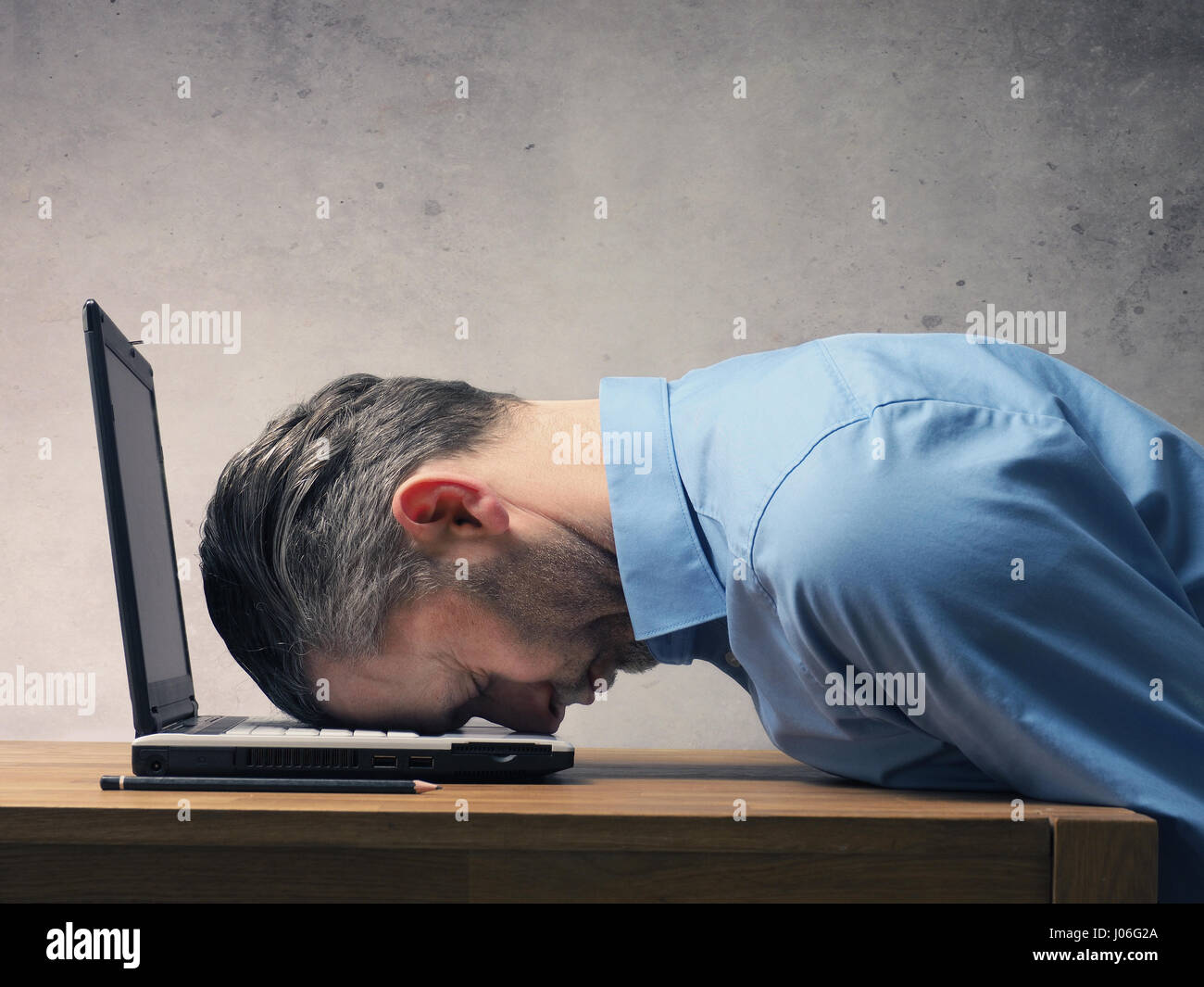 Handsome business man sleeping on a laptop Stock Photo - Alamy